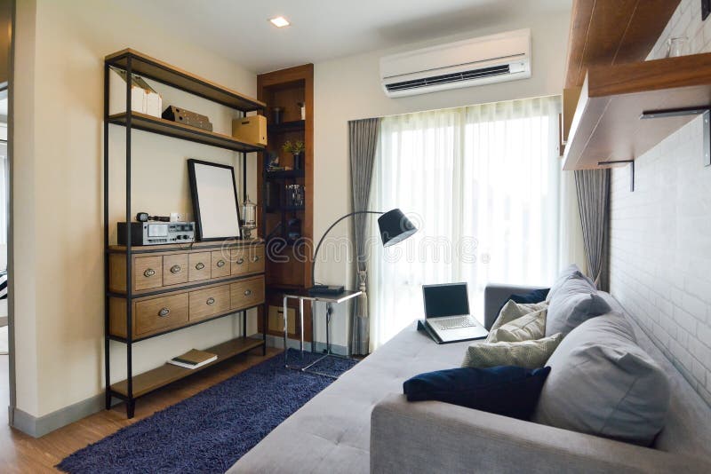 Laptop Computer Placed on Sofa in Blue Tone Modern Living Room beside ...