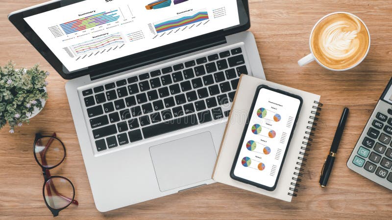 Laptop Computer and Smart Phone with Charts and Reports on Screen ...