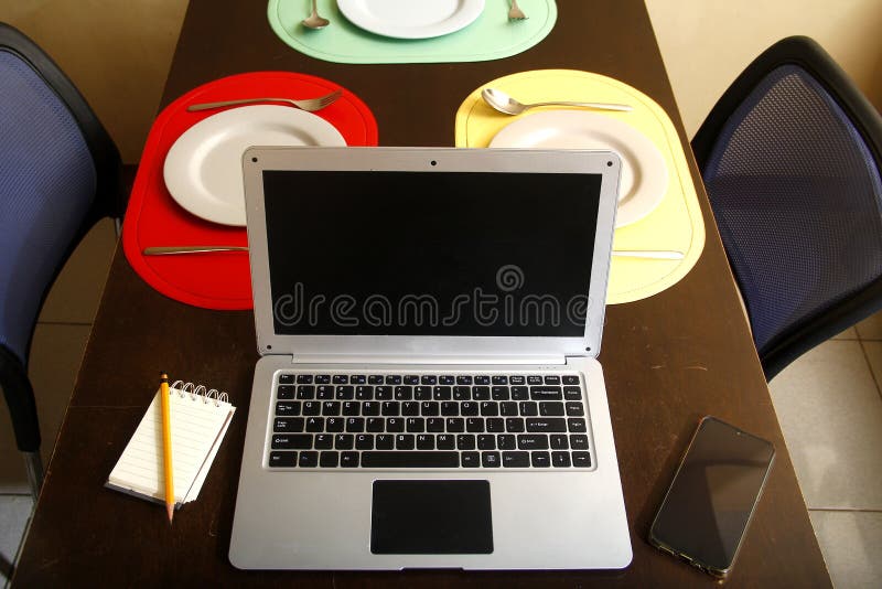 Laptop Computer, Smartphone, Notebook, Pencil, Plates and Utensils on a ...