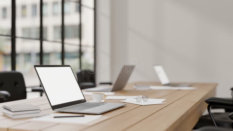 A Laptop Computer with a White Screen Mockup on a Meeting Table in a ...