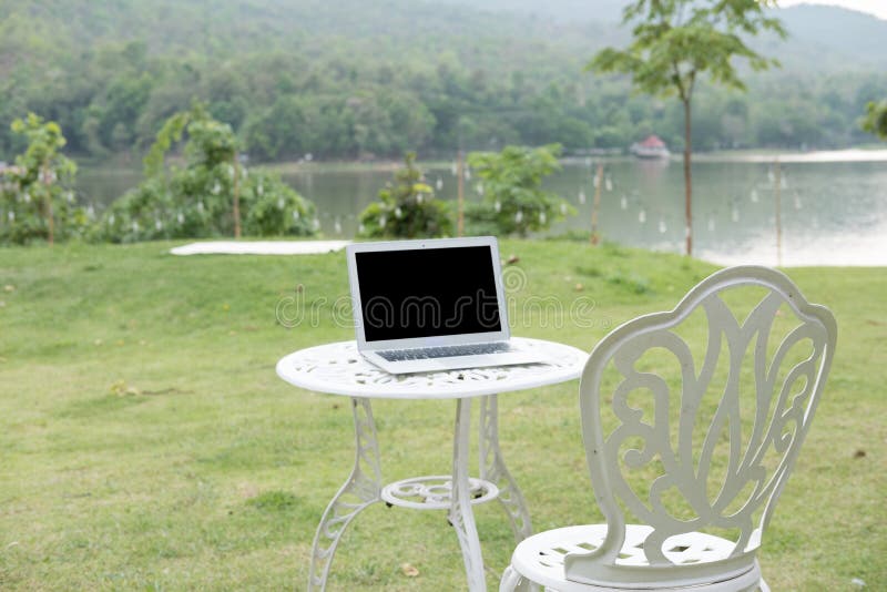 Laptop Computer on White Table in Garden. Freelance or Remote Work ...