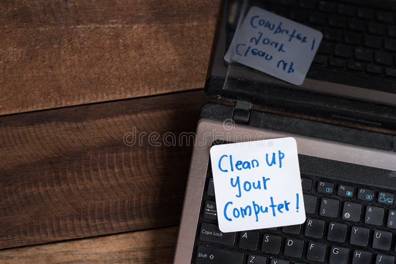 Laptop Computer on Wooden Table with Note CLEAN UP YOUR COMPUTER Stock ...