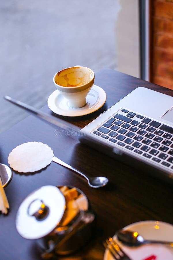 Laptop and Cup of Coffee on a Table Stock Image - Image of liquid ...