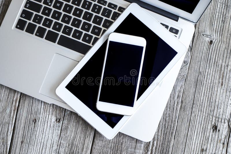 Laptop with Digital Tablet and Mobile Phone on Wooden Table Stock Image ...