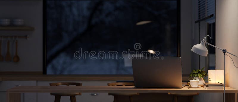 A Laptop on a Dining Table in a Contemporary Kitchen at Night with a ...