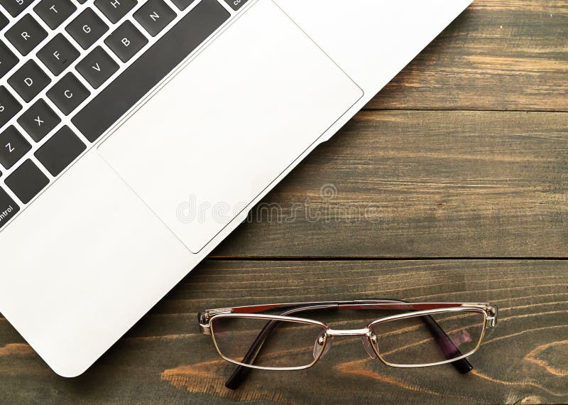 Laptop and Eyeglasses on Table Stock Photo - Image of study, lenses ...