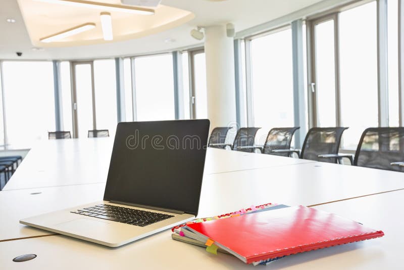 Laptop and Files on Conference Table in Creative Office Stock Photo ...