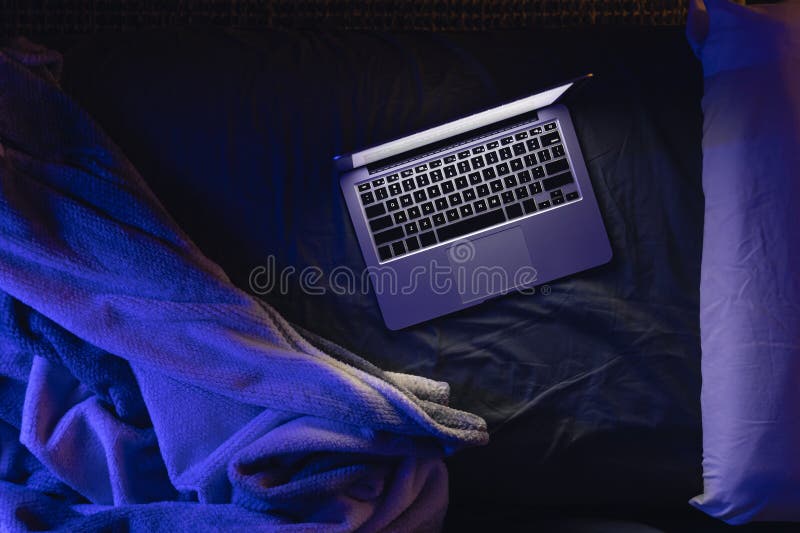 Laptop with Glowing Screen on Bed at Night, Top View, Copy Space. Stock ...
