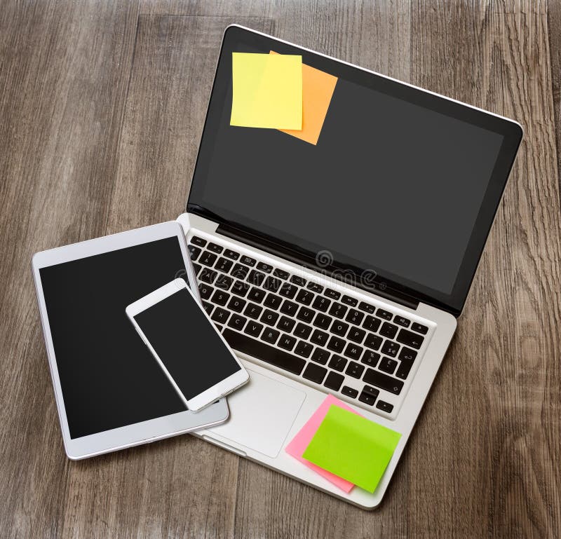 Laptop in High Definition with Tablet and Mobile Phone on a Wood Stock ...