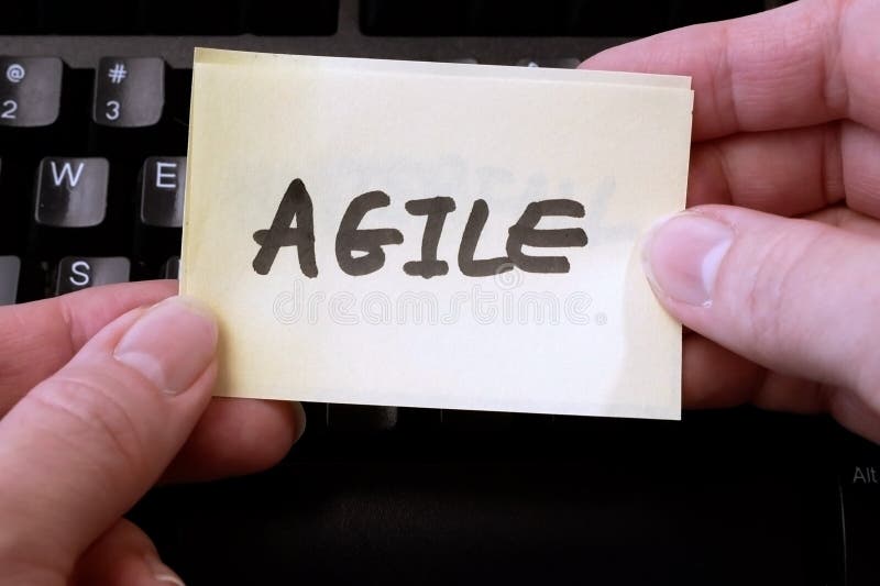 Laptop Keyboard and Hand Puts Paper Sticker with Agile Title, Software ...