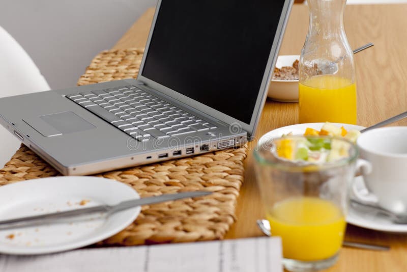 Laptop on a kitchen table. stock image. Image of home - 11451113