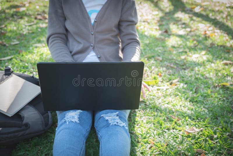 Laptop on the Lap of a Woman Sitting on the Lawn. Stock Image - Image ...