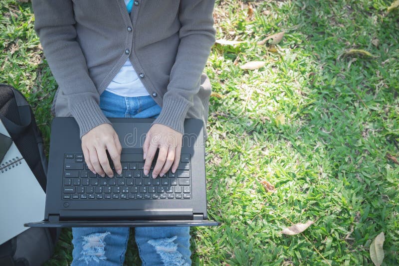 Laptop on the Lap of a Woman Sitting on the Lawn. Stock Image - Image ...