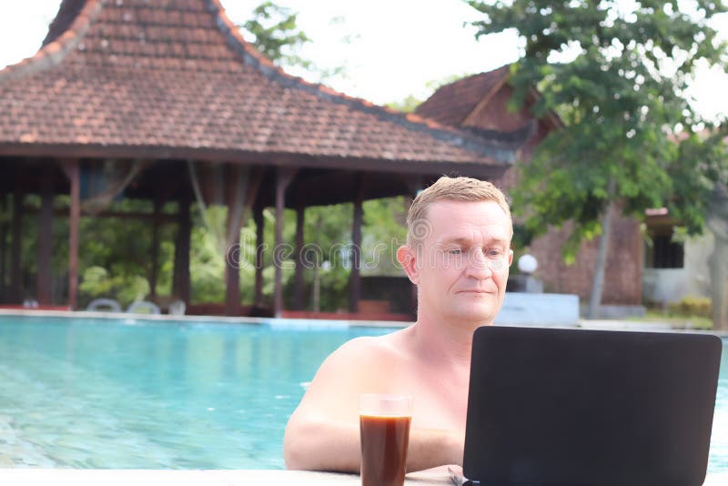 Laptop that a Man is Using in the Swimming Pool on Vacation. Overtime ...