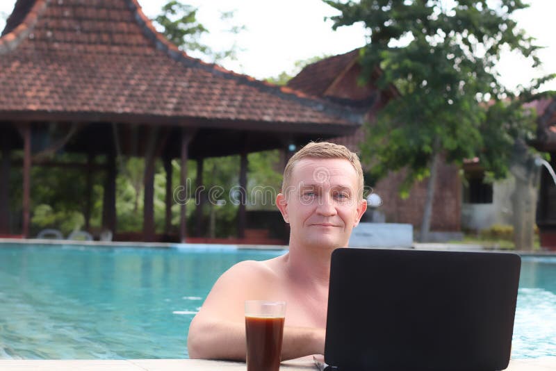 Laptop that a Man is Using in the Swimming Pool on Vacation. Overtime ...