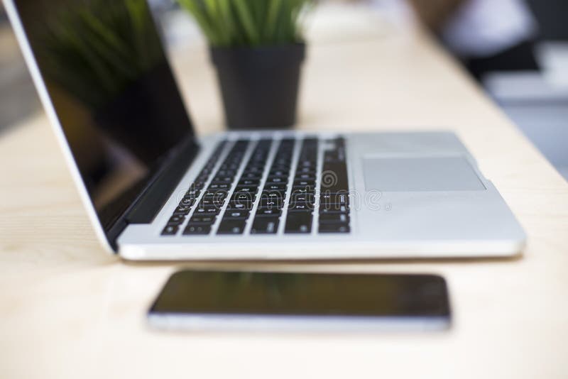 Laptop and Mobile Phone on a Desk Editorial Stock Photo - Image of ...