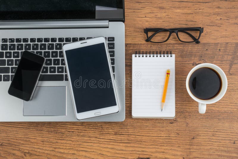 Laptop Mobile Phone and Tablet with Notebook on the Desk Stock Image ...