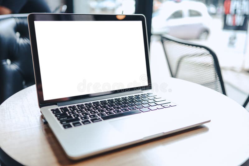 Laptop with Mock Up Blank Screen on Wooden Table in Front of Cafe Space ...