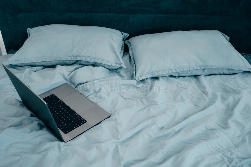 Laptop in the Morning on a Blue Sheets Bed. Work from Home. Freelance ...