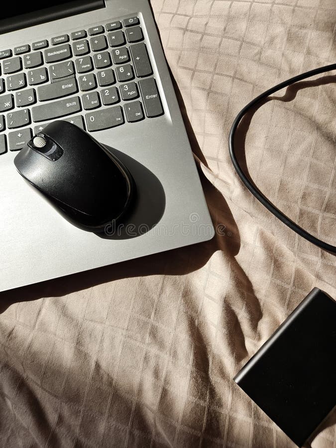 Laptop and Mouse on Bed with Sunlit Texture Stock Photo - Image of ...