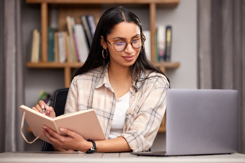 Laptop, Notebook and Learning with a Student Woman in a University Library To Study for a Final ...
