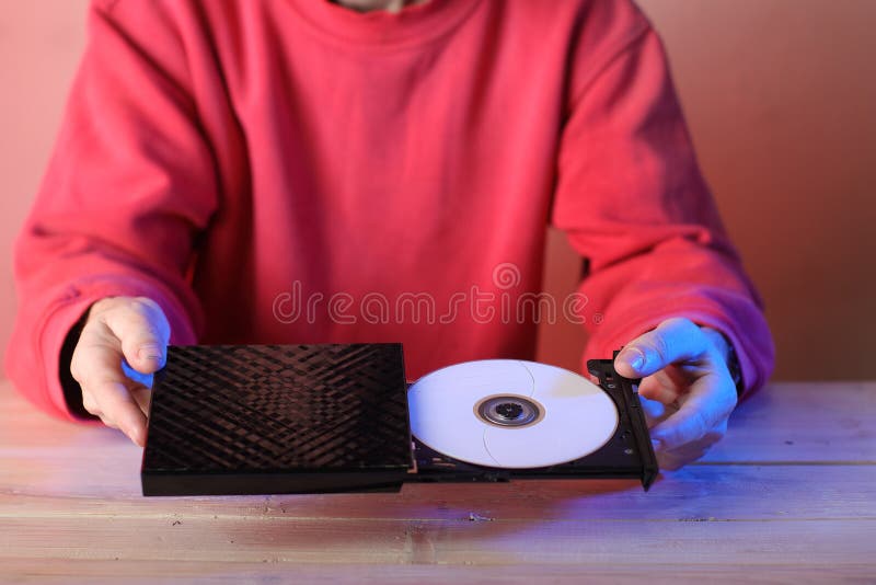 Laptop Optical Drive with Compact Disc in Hands on Table Stock Photo ...
