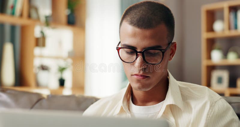 Laptop, Remote Work and Thinking with Man on Sofa in Living Room of Home for Administration or ...