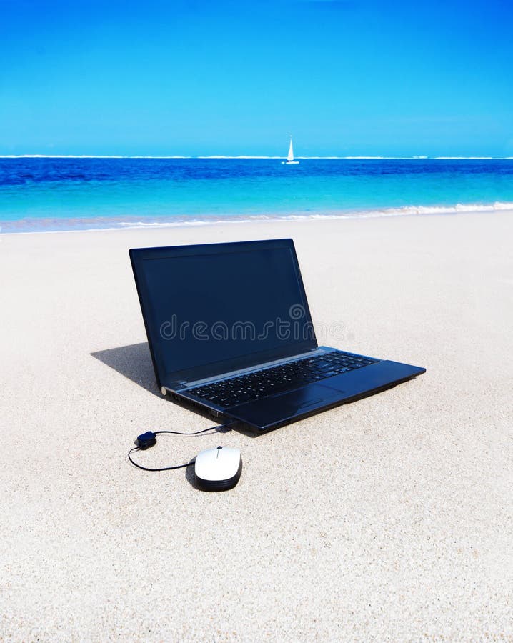Laptop on the sand beach stock image. Image of electronic - 42494239