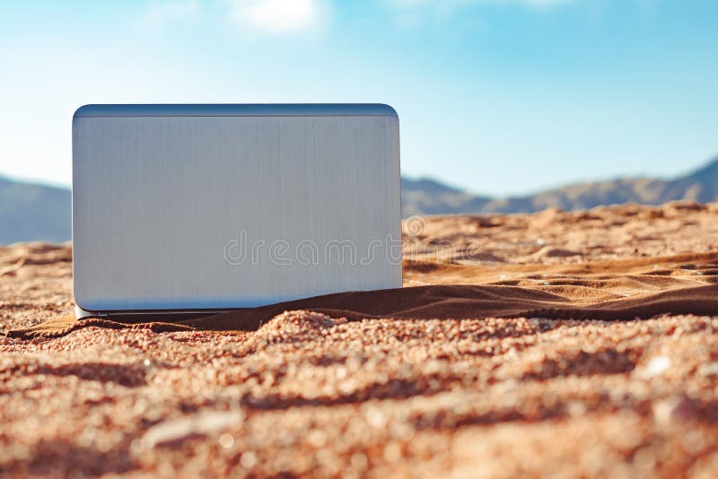 The laptop in the sand stock image. Image of nature - 138949455