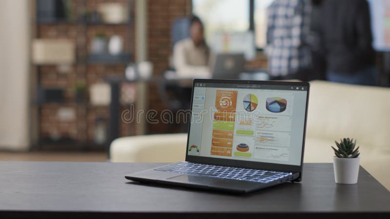 Laptop Screen with Financial Charts and Graphs on Office Desk Stock ...