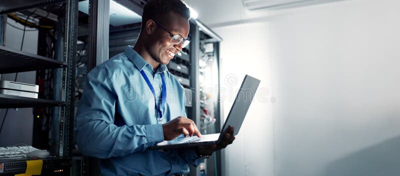 Laptop Server Room And Black Man On Network For Maintenance Programming Software Or Typing
