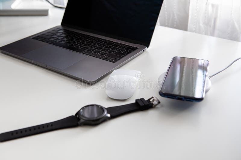 Laptop with Smart Watch Computer Mouse and Phone Charging on Wireless ...