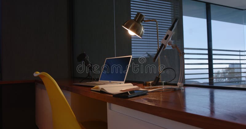 Laptop and Smartphone on Desk with Notebook and Lamp in Home Office ...