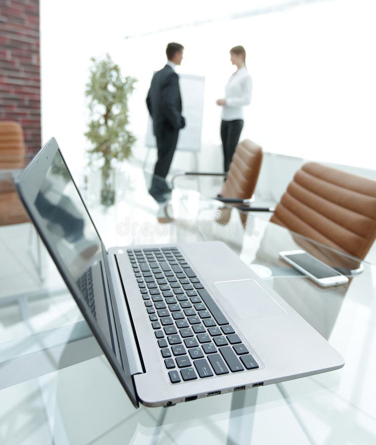 Laptop and a Smartphone on the Desktop in the Conference Room. Stock ...