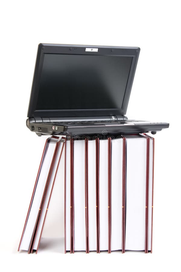 Laptop on a stack of books stock photo. Image of conceptual - 13526200