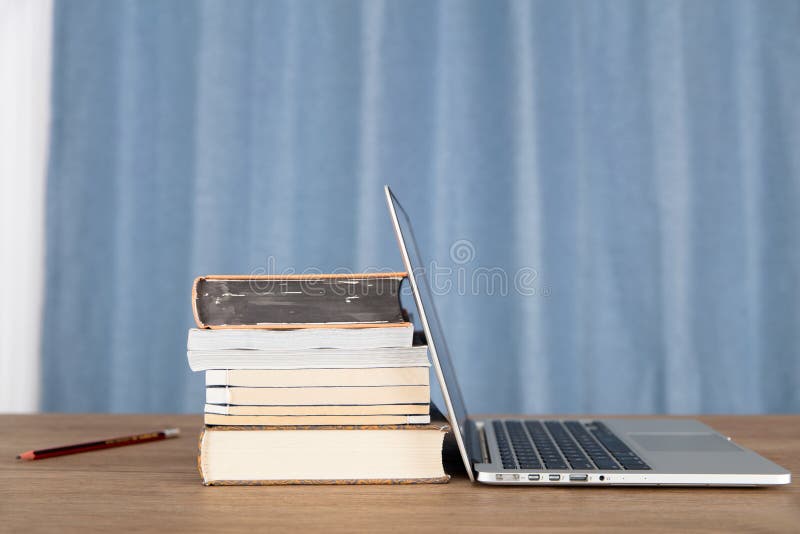 Laptop and stack of books stock image. Image of remote - 253779667