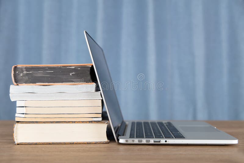 Laptop and stack of books stock image. Image of people - 253779671