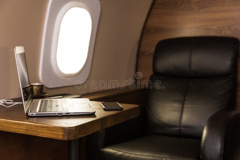 Laptop on the Table in the Interior of a Private Jet. Flying First ...