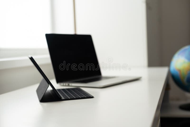 Laptop and Tablet on a White Table Stock Image - Image of computer ...