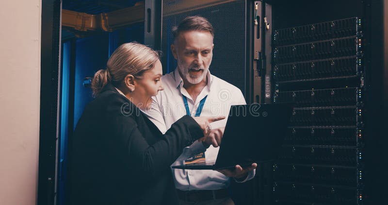 Laptop, Talking and People with in Server Room for Technical Support, Database or Cybersecurity ...
