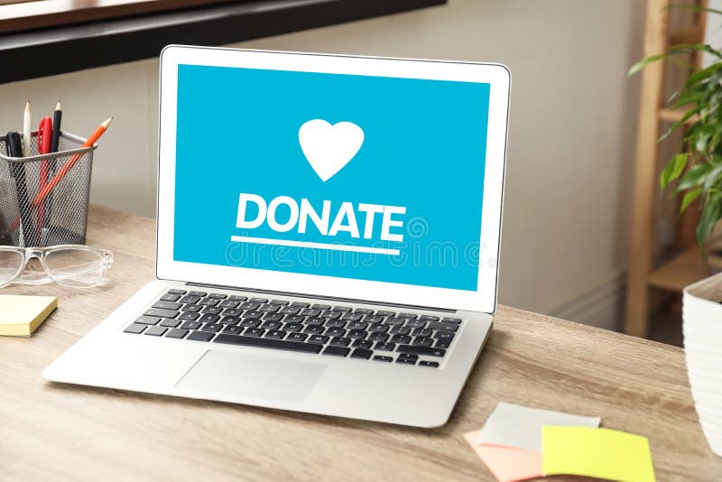 Laptop with Text DONATE on Table Indoors Stock Image - Image of give ...