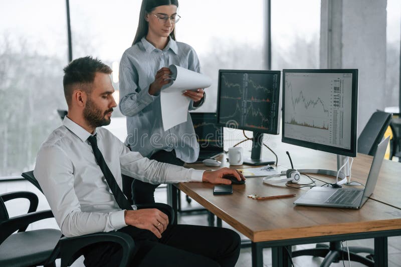 With Laptop. Two Employees are Working in the Office Together Stock ...