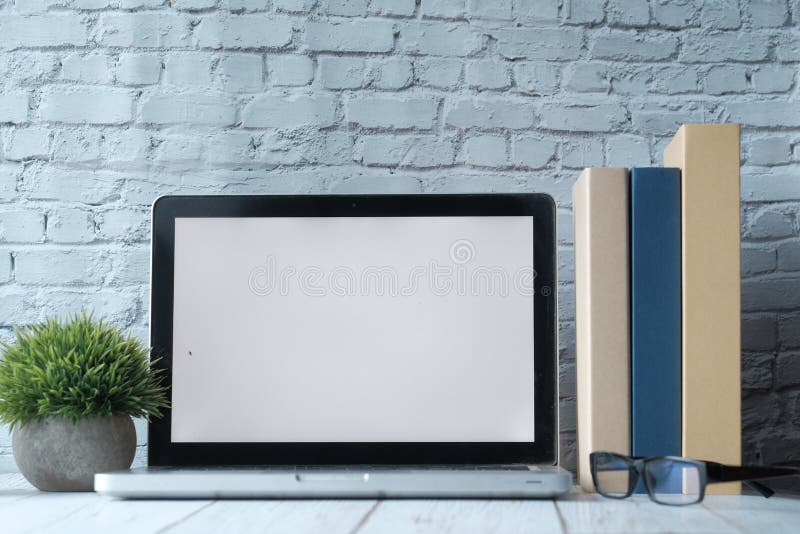 Laptop with White Screen and Stack of Book on Table Stock Image - Image ...