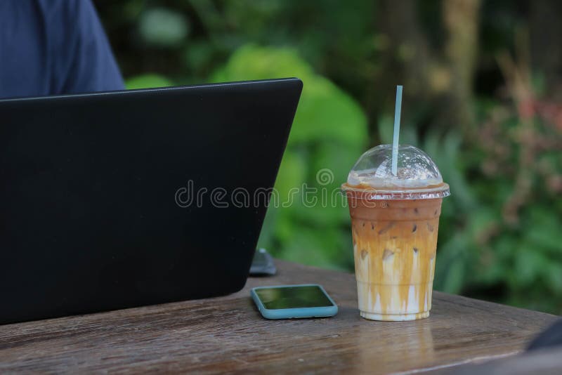 Laptop on Wooden Desk with Iced Coffee in the Cafe Stock Photo - Image ...