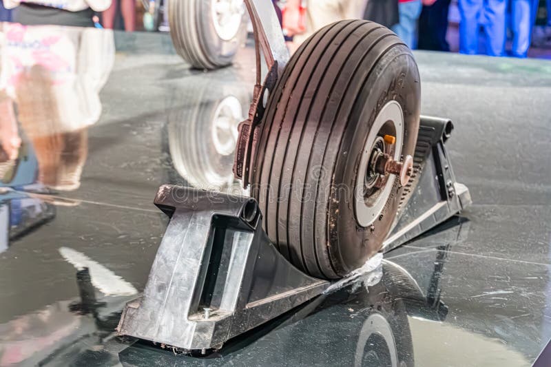 Large Airplane Wheel on a Maintenance Stand, Viewed from Below Indoor ...