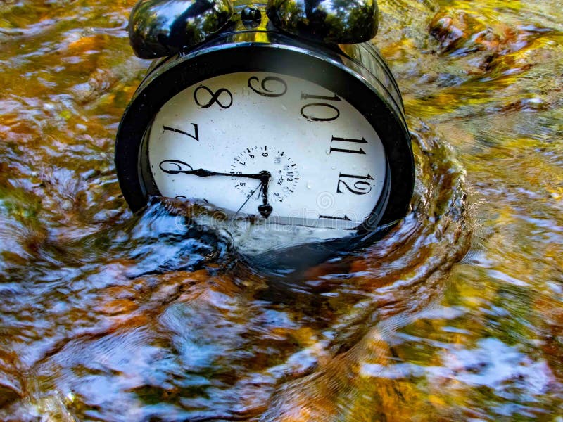 A Large Alarm Clock Half Submerged in a Beautiful Flowing Stream Stock ...