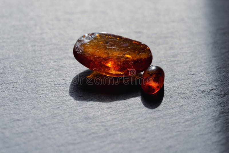 Large Amber Stone Illuminated by Sunlight on a Black Background Close ...