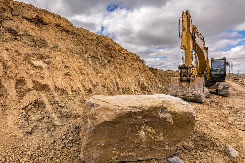 Large Amount of Stone and Earth Moved by a Yellow Excavator Stock Photo ...
