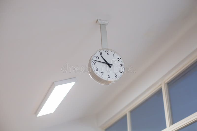 Large Analog Clock Hanging from Ceiling Stock Photo - Image of room ...