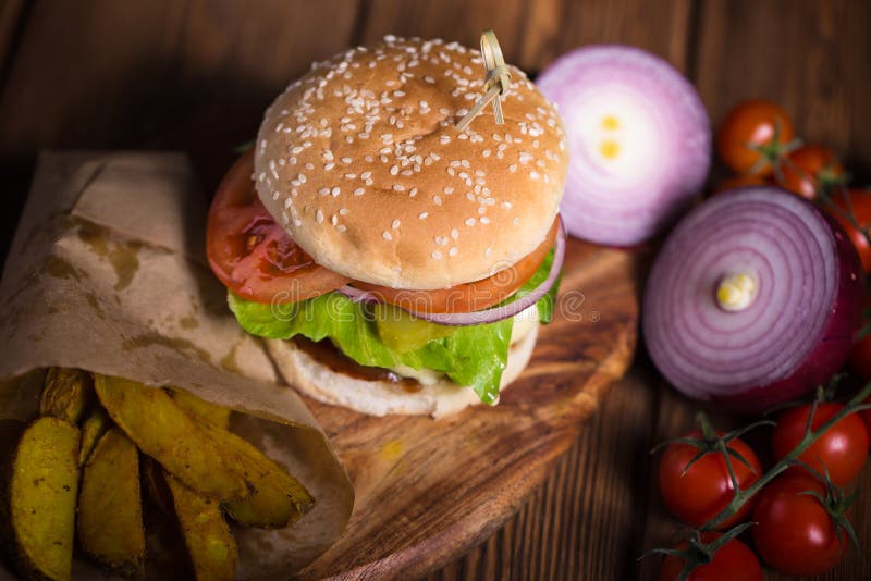 Large Appetizing Burger With Beef, Potatoes And Cheese On A Wooden ...